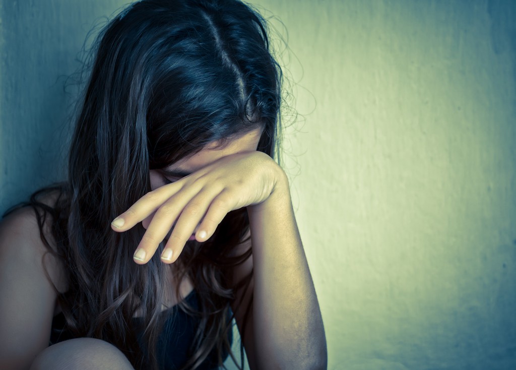 lonely-girl-crying-with-a-hand-covering-her-face-navlabs